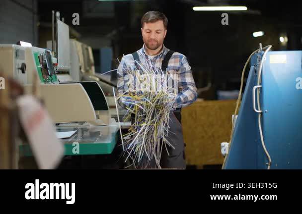 Male technician in uniform working at a printing plant. Focused man ...