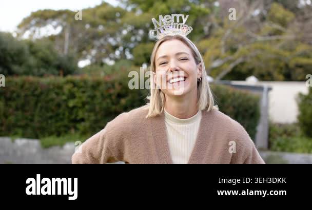 Noticing visitor mid-adult female greeting and laughing tilting head at ...