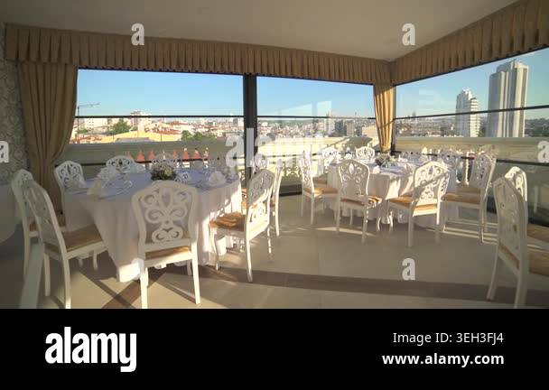 Wedding reception tables, place settings and empty chairs prepared ...