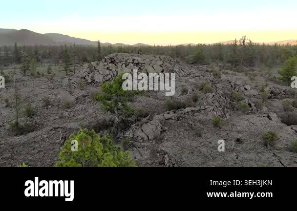 Basalt lava dome rises from cracked volcanic plain where trapped gas ...