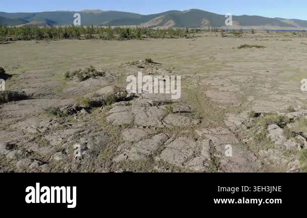 Drone aerial view shows frozen basalt lava plain with cracked rock ...
