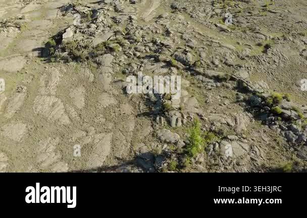 Drone aerial view shows frozen basalt lava plain with cracked rock ...