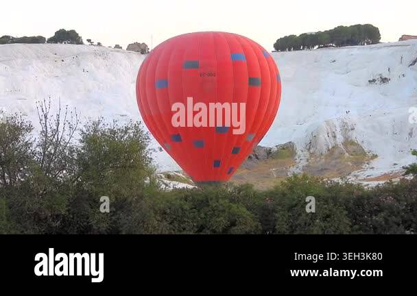 Red hot air balloon above Pamukkale travertines in Denizli, Turkey at ...