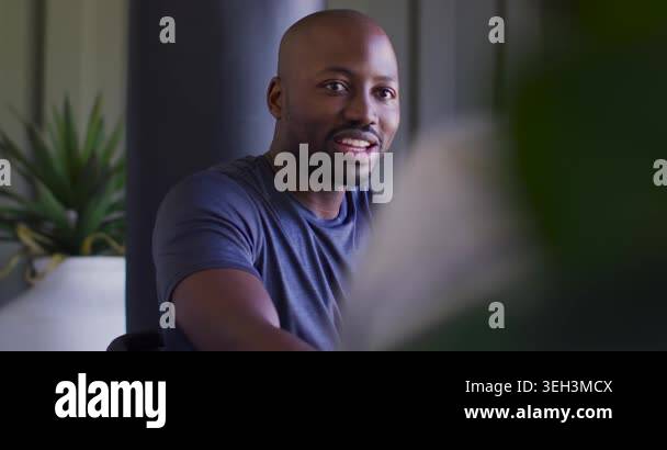 African American man navy-tee gesturing right, responding off-frame ...