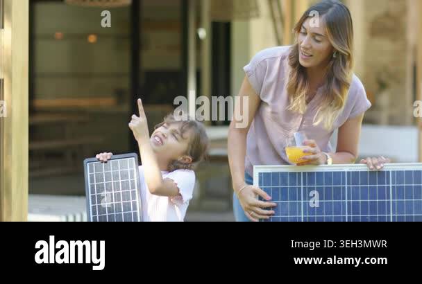 Family child on patio, sun guiding girl pointing panel, parents holding ...