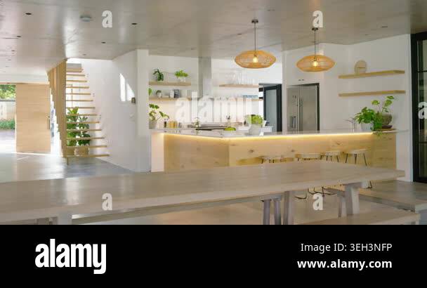 Camera is sliding forward, bringing wooden kitchen island into frame to ...