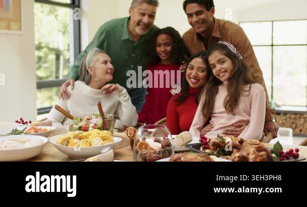 Diverse family leaning as grandmother gesturing to chicken, smiling and ...