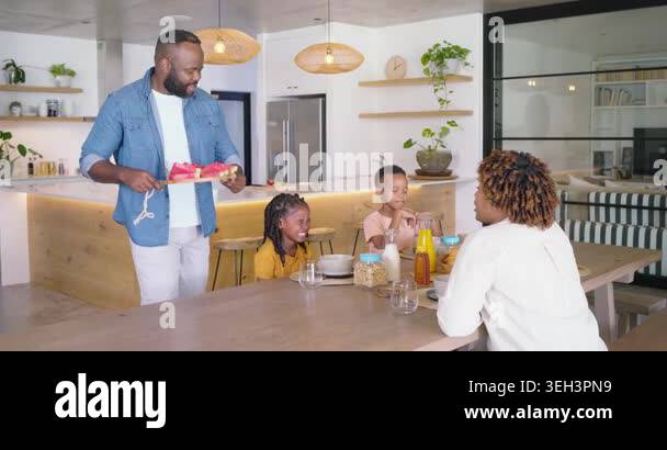 African American family seeing dad walking with watermelon tray ...