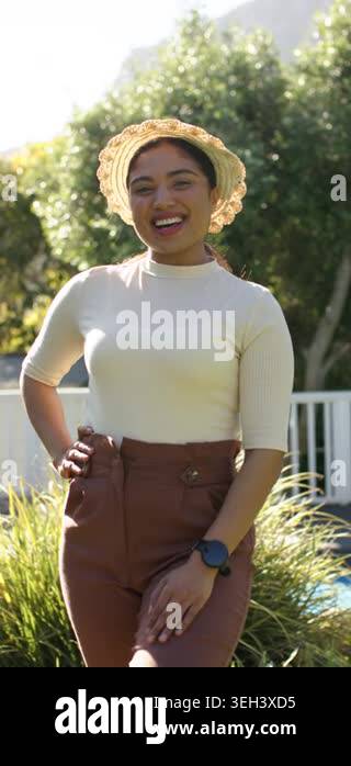 Vertical video: Sunlight sparking laughter, woman tilting head and ...