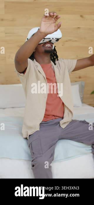 Vertical video: Man wearing white VR headset reaching for virtual ...