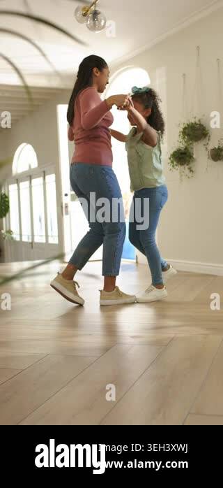 Vertical video: Mother and daughter playing, holding hands while mother ...