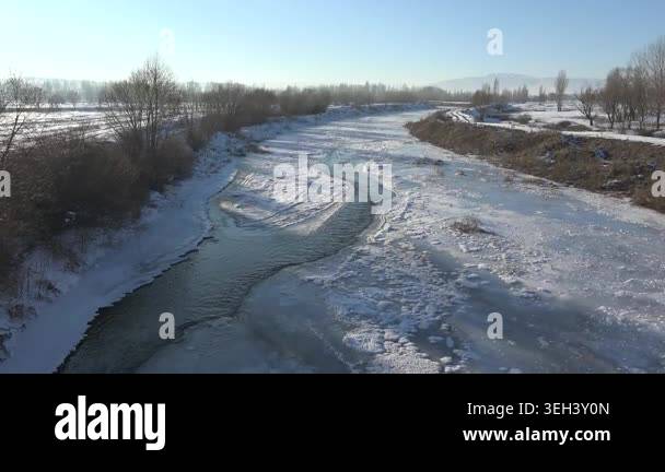 Frozen river waters with ice covered surface in extremely cold weather ...