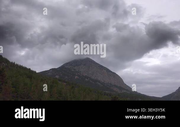 Time lapse dark clouds collecting on mountain peaks in Balkan range ...
