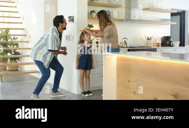 Family dad coming from left, holding yellow tape, measuring girl height ...
