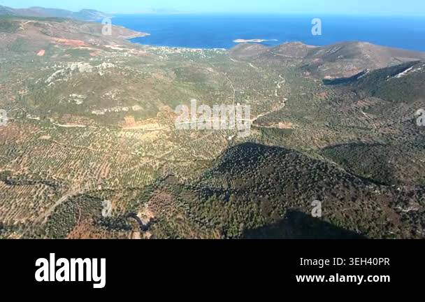 Olive groves line the Mediterranean coast of Turkey, meeting blue water ...