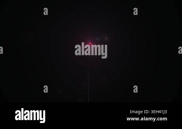 A small red light on dark background Stock Video Footage - Alamy