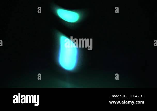 Glowing blue lights against black background Stock Video Footage - Alamy