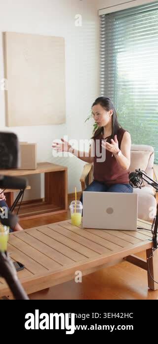 Vertical video: Diverse women hosts recording box reveal in studio ...