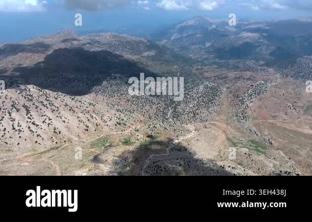 Aerial view of sparsely forested mountains and valleys in northern ...