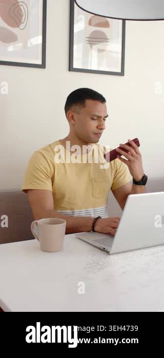 Vertical video: Man picking up phone, calling, tapping screen and ...