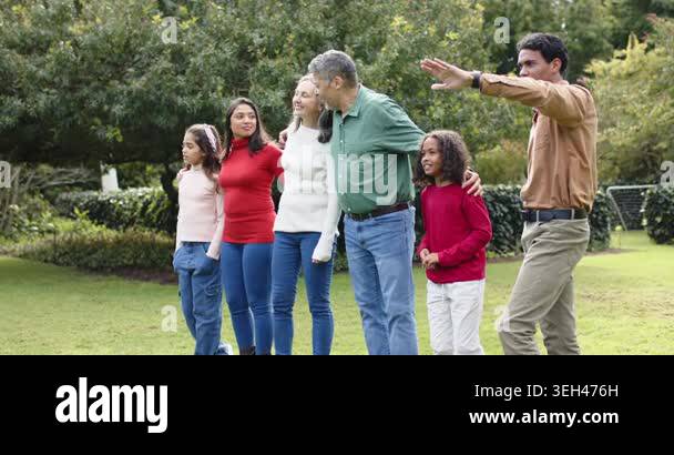 Extended family responding to youngest man raising arm, clustering and ...