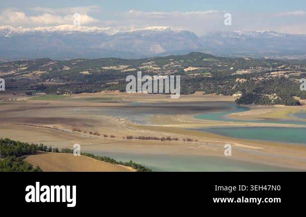 Descending lake basin reveals sandy littoral drift caused by drought ...