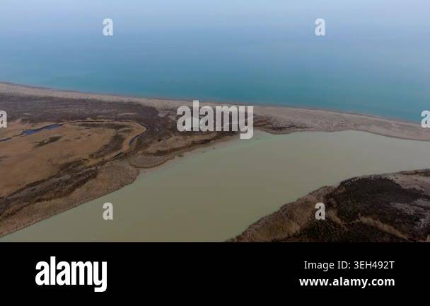 Panoramic aerial view of longshore drift sands shaping river mouth on ...