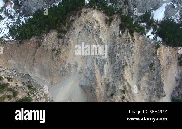 Aerial view of massive landslide tearing through forested mountain ...