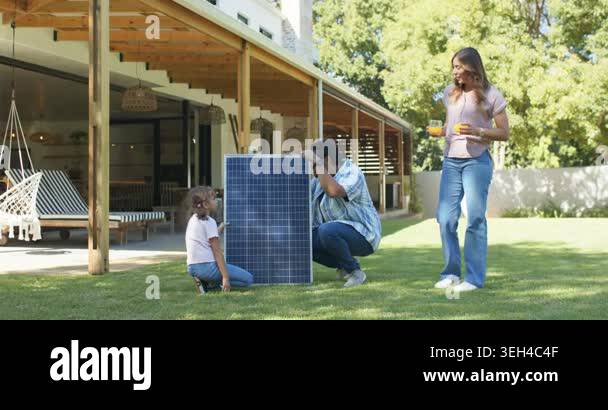 Parents teaching solar in yard after panel upright by porch, child ...