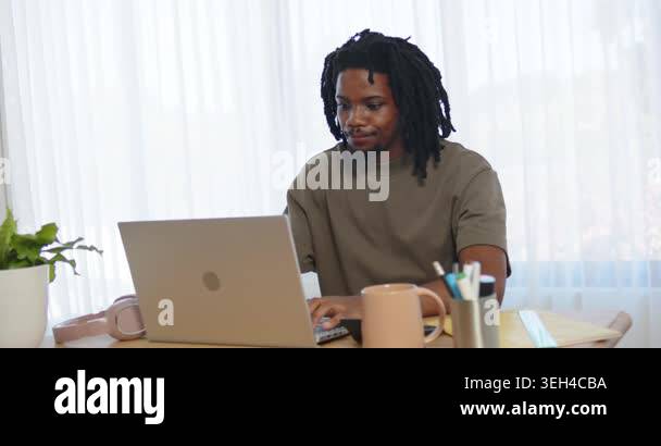 African American man wearing olive T-shirt starting work session ...
