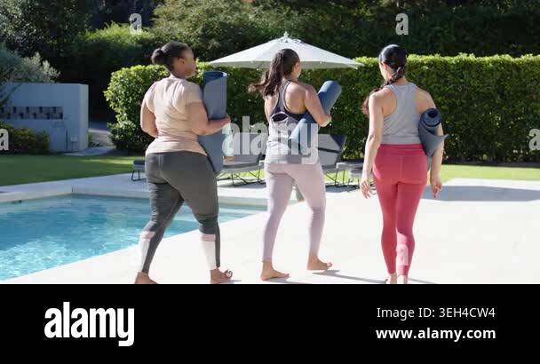 After bottle pass Diverse female friends in activewear walking pool ...