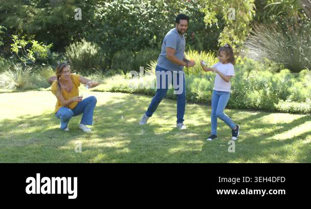 African American family woman dipping wand, man blowing bubbles, girl ...