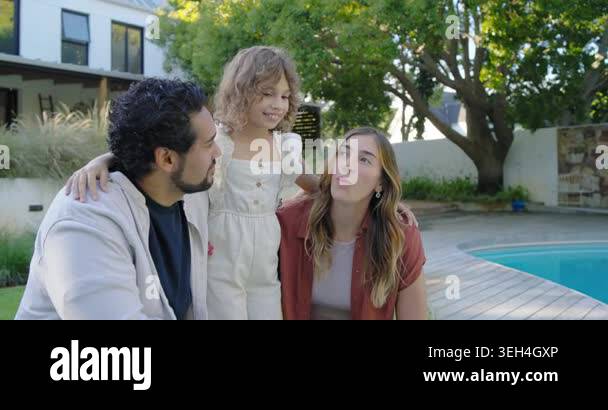 Family of three listening and smiling while child speaking and ...