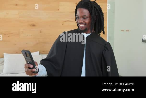 African American man 20s raising phone to join call in bedroom, smiling ...