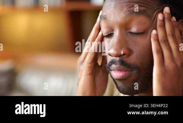 African American man feeling tension, pressing temples and rubbing ...