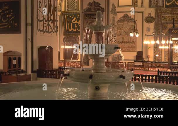 Fountain pool inside Bursa Ulu Mosque at night with reflections and ...