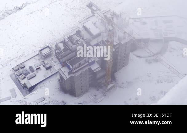 Snow covered construction site in winter storm shows active building ...