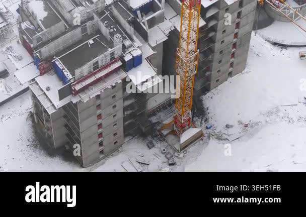 Snow covered construction site in winter storm shows active building ...