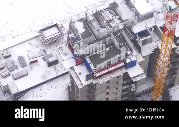 Snow covered construction site in winter storm shows active building ...