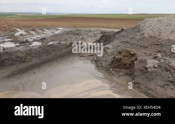 Muddy water swirls with thick sediment in a close industrial view of ...