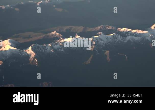 Snowy mountain summit dominates vast landscape, steep ridges and high ...