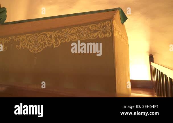 Cloth covered caskets rest inside Islamic tomb, sacred interior ...