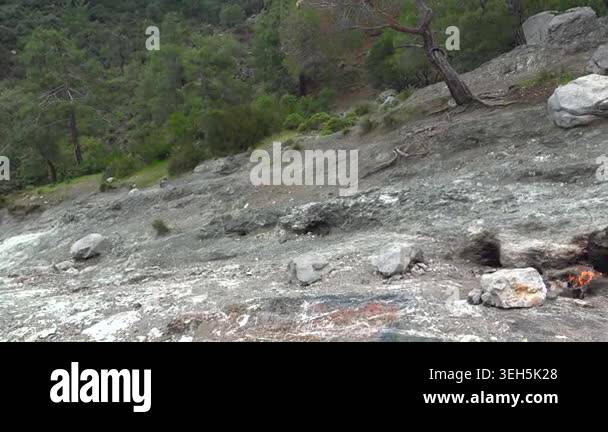 Methane burns from a crack in rock as natural gas escapes and ignites ...
