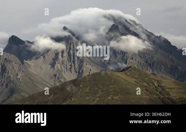 Rocky Mountains fog timelapse over rugged peaks as clouds spill across ...