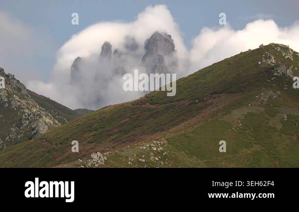 Dolomites mountains timelapse with fast clouds and fog around rocky ...