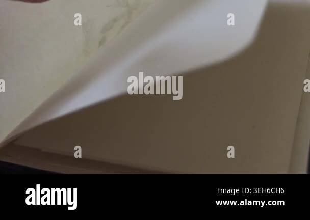 Slow motion close-up footage of a hand gently turning and smoothing a ...