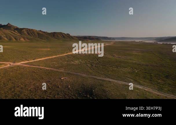 Aerial view Drone shot of river Ili and spring steppe at subset cloudy ...