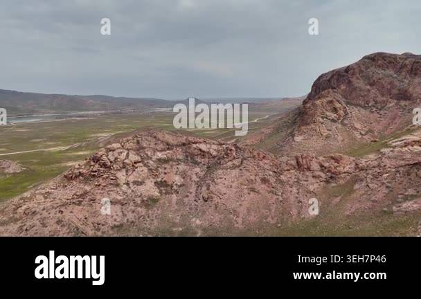 Aerial view Drone shot of rocky mountains, river Ili and spring steppe ...