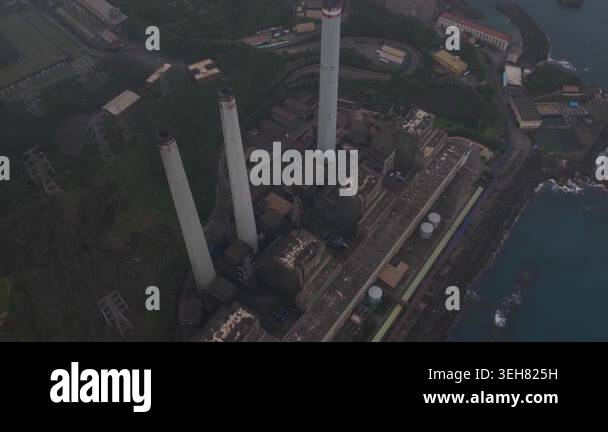 High angle aerial shot slowly revealing a massive coal fired power ...
