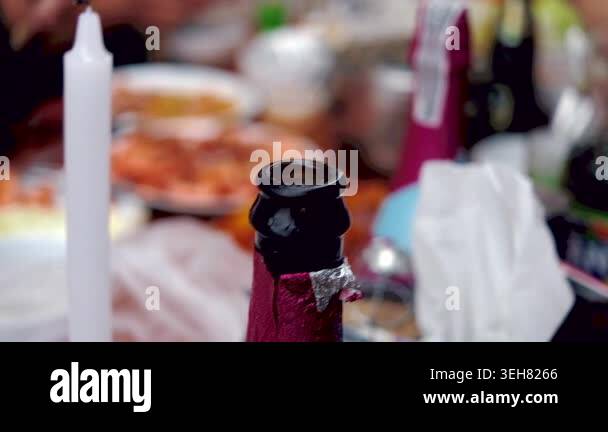 Close-up of an Open Champagne Bottle on a Messy Party Table After a ...